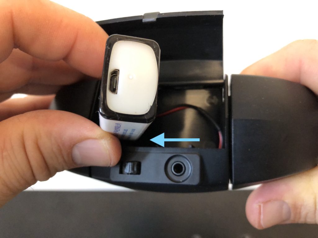 The battery should lay flat and not obstruct the battery door.